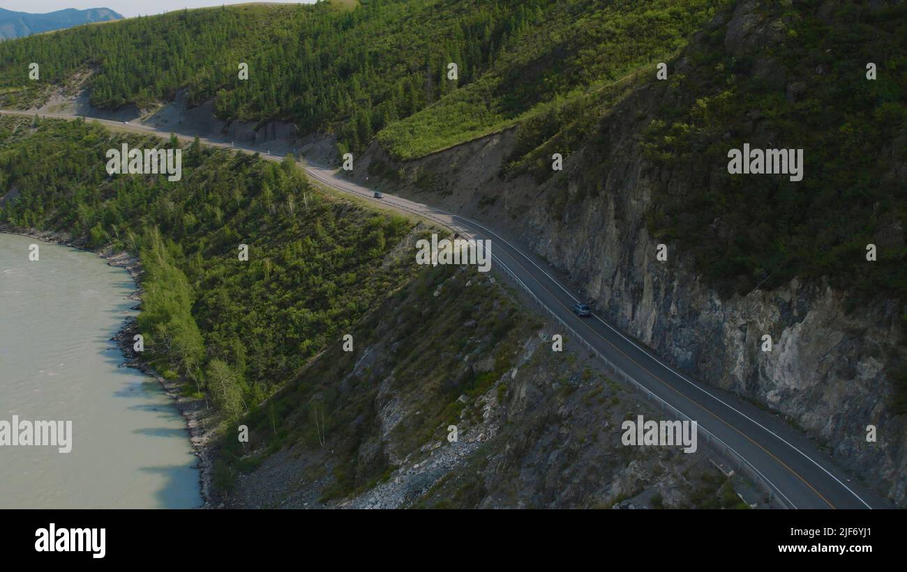 Traffic cars on Chuya highway road between mountains and Katun river in ...