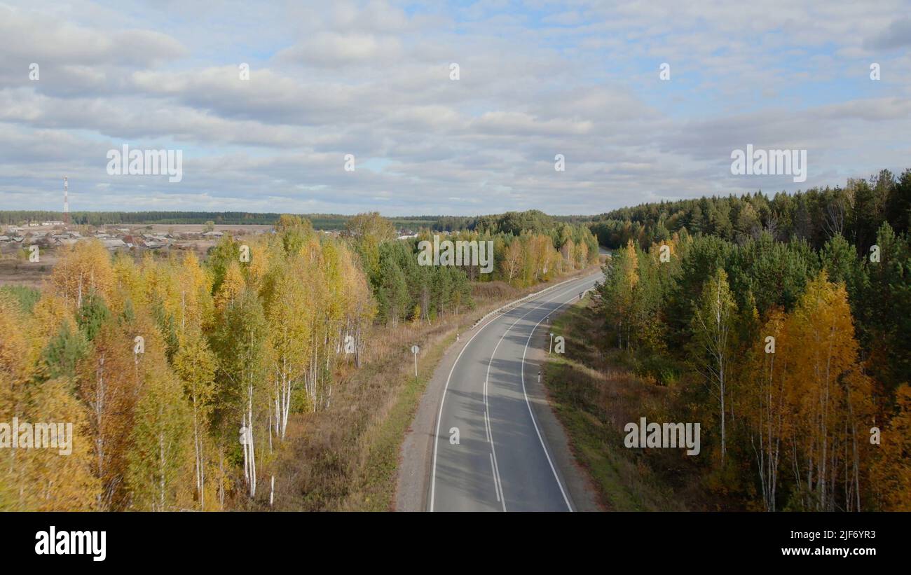 Asphalt road with traffic cars between forest in Ural, Russia ...