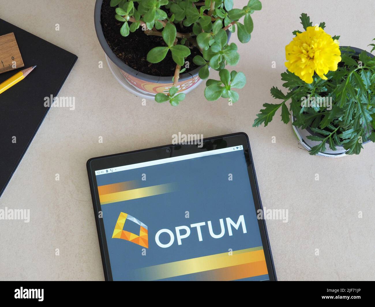 In this photo illustration, Optum, Inc. logo seen displayed on a tablet ...