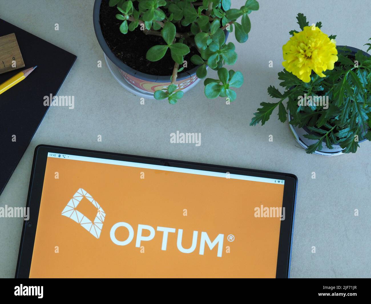In this photo illustration, Optum, Inc. logo seen displayed on a tablet ...