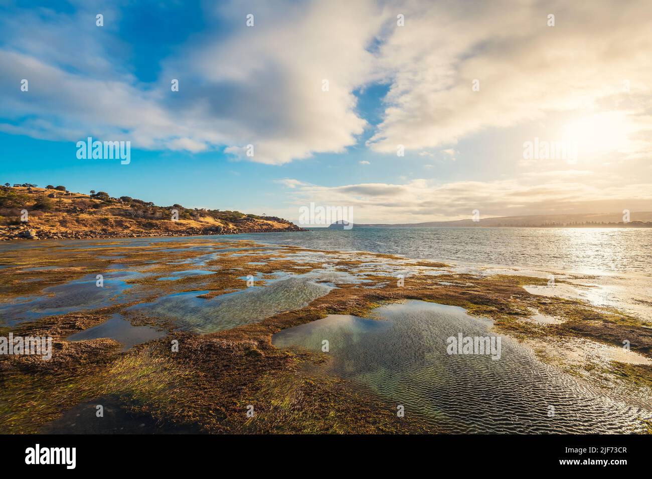 Iconic Granite Island at sunset viewed from the causeway during low ...