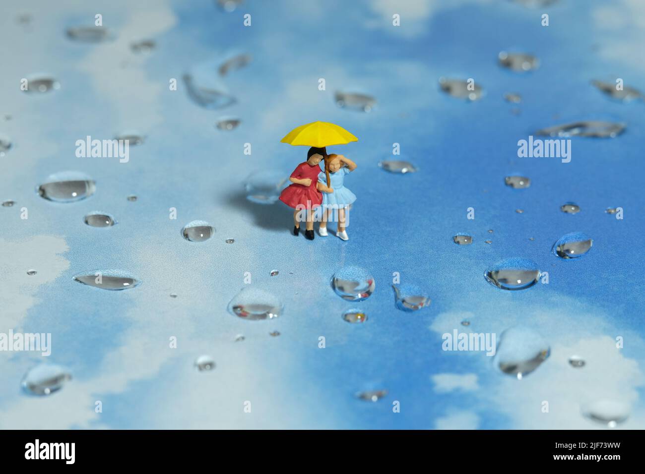 Miniature people toy figure photography. Two girls kid playing outside ...