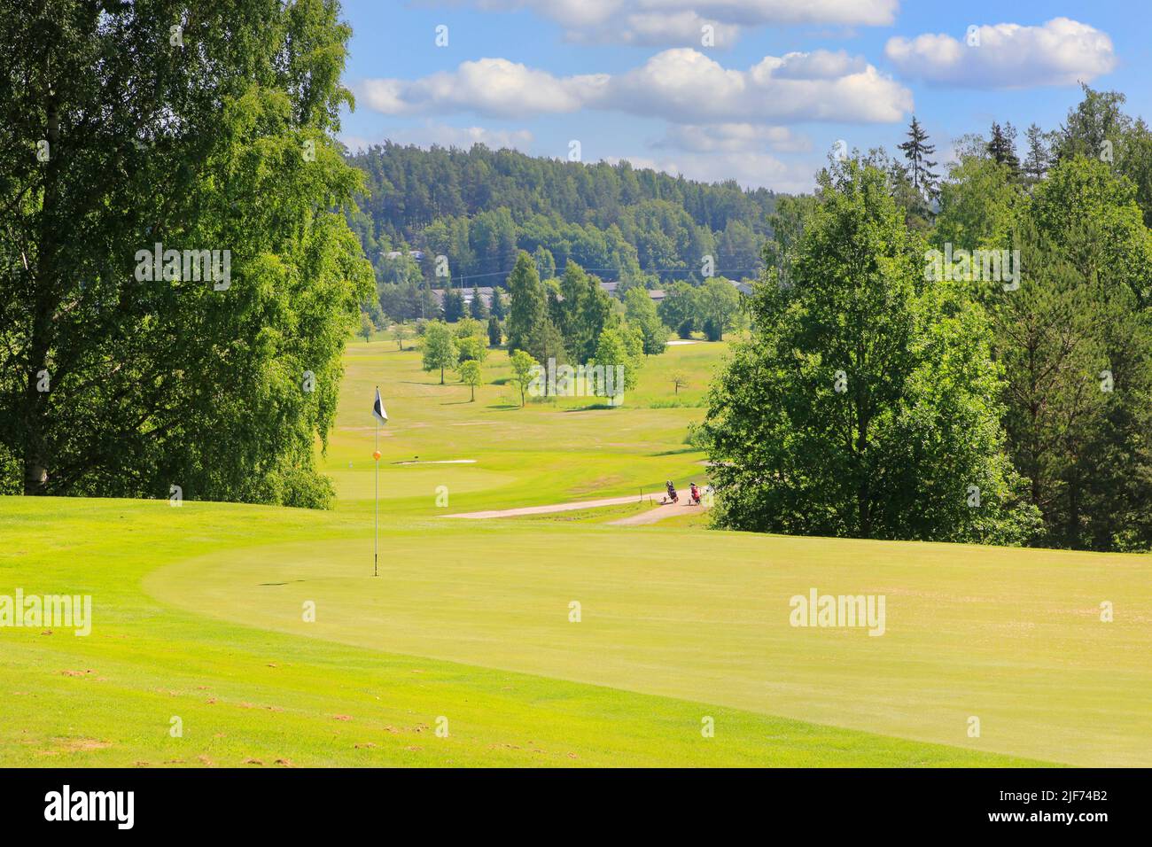 View to an idyllic golf course on a beautiful day of summer with golf ...