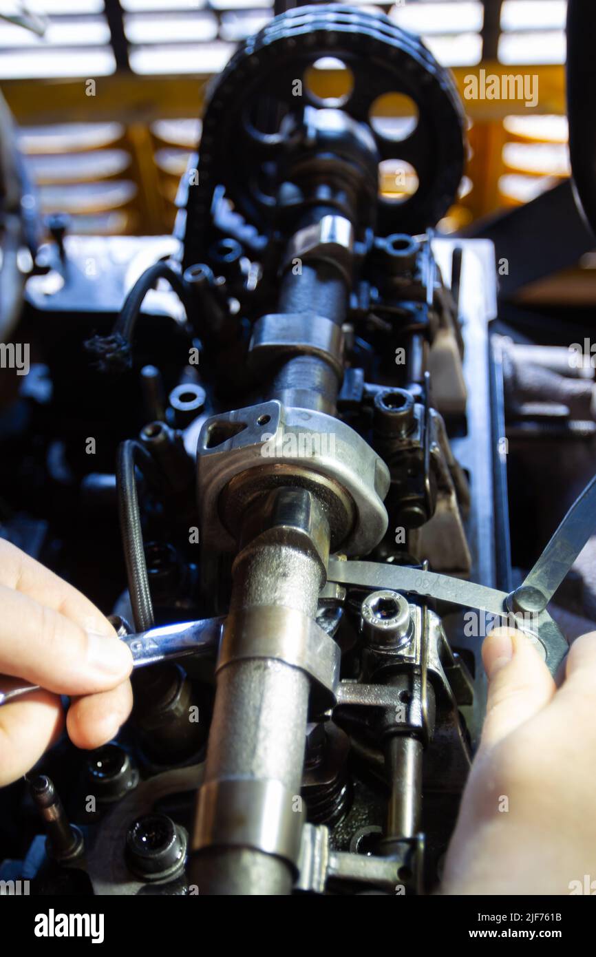 Mercedes diesel engine repair. Hands with a mechanic repairing Mercedes ...