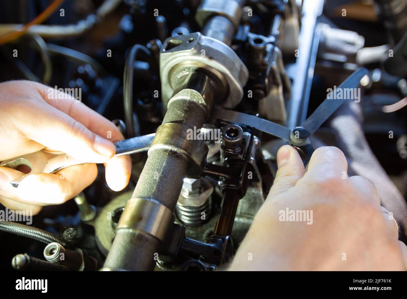 Mercedes diesel engine repair. Hands with a mechanic repairing Mercedes ...