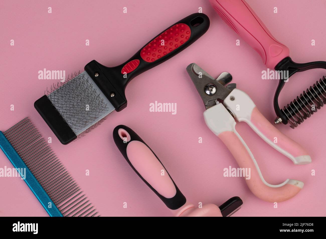 Tool for the groomer on a pink background. Dog grooming accessories ...