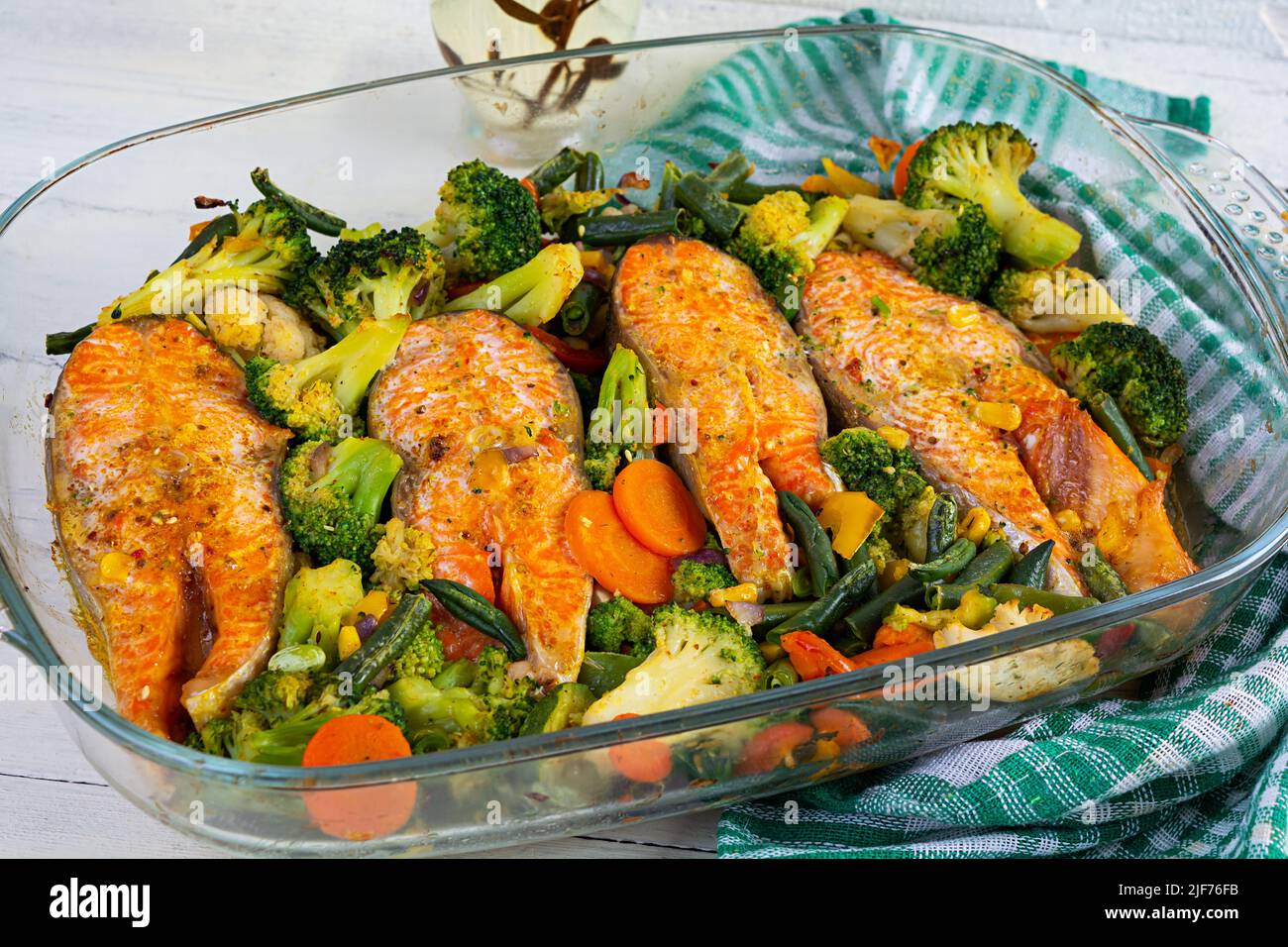 Baked salmon fillet with green vegetables. Fillet fish with herbs and ...