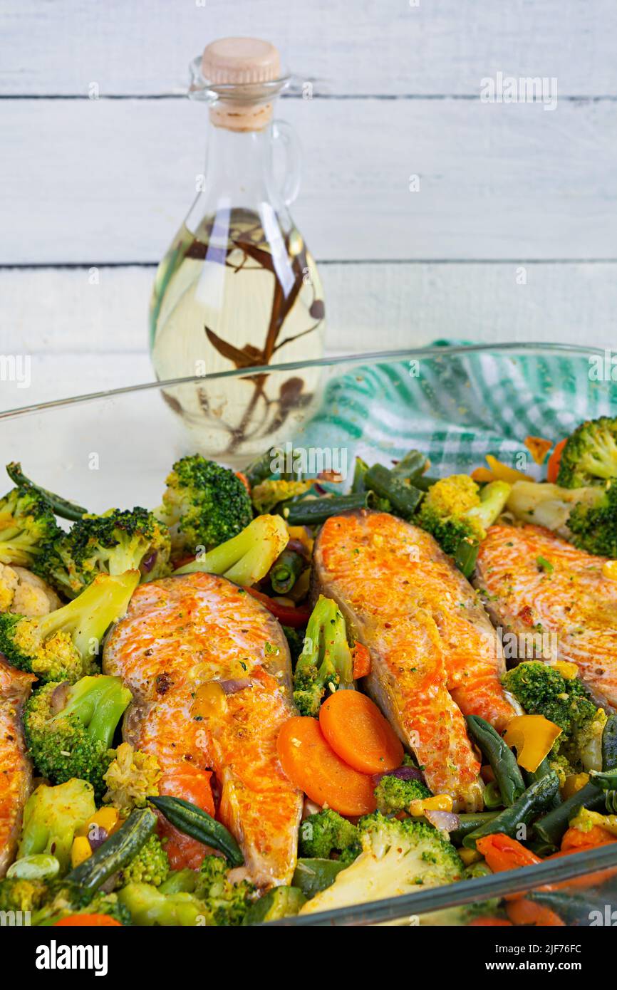 Baked salmon fillet with green vegetables. Fillet fish with herbs and ...