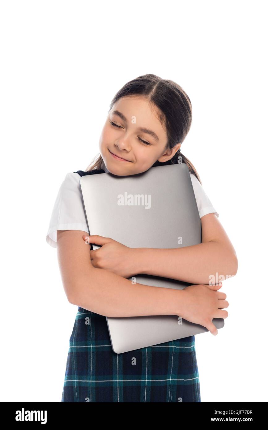 Portrait of smiling schoolgirl hugging laptop isolated on white Stock ...
