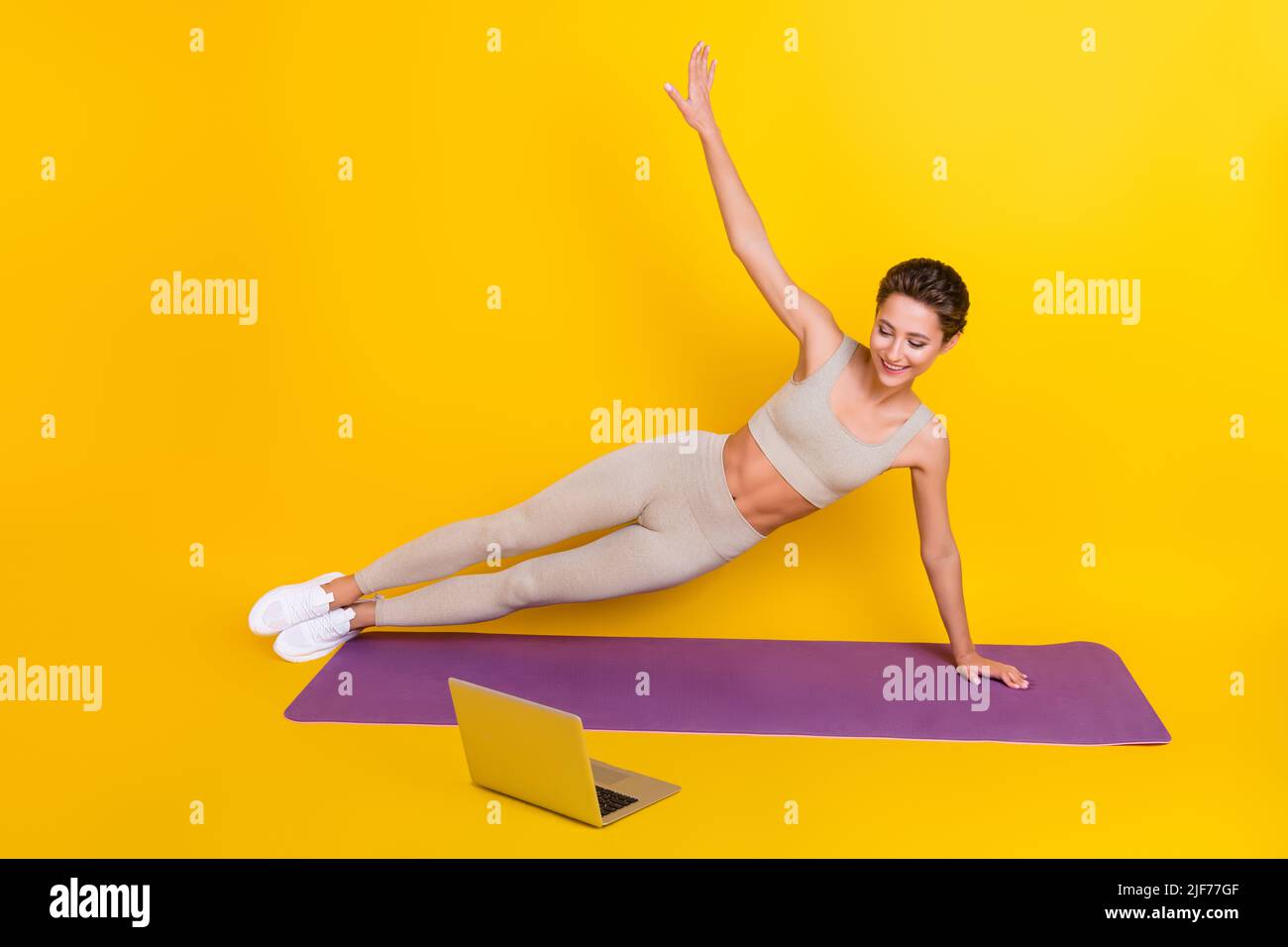 Portrait of attractive sportive cheerful girl doing physical exercise ...