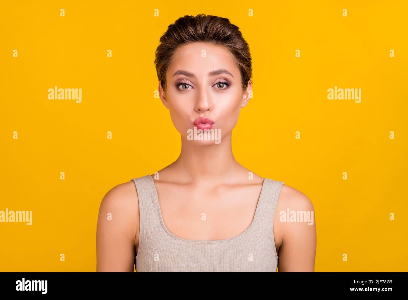 Photo of romantic affectionate lady lips send air kiss wear grey top ...