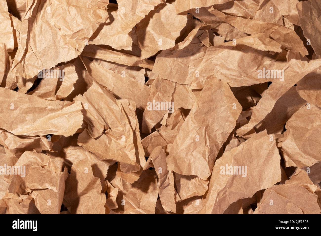 Multiple pieces of torn brown crumpled, wrinkled recycle craft paper ...