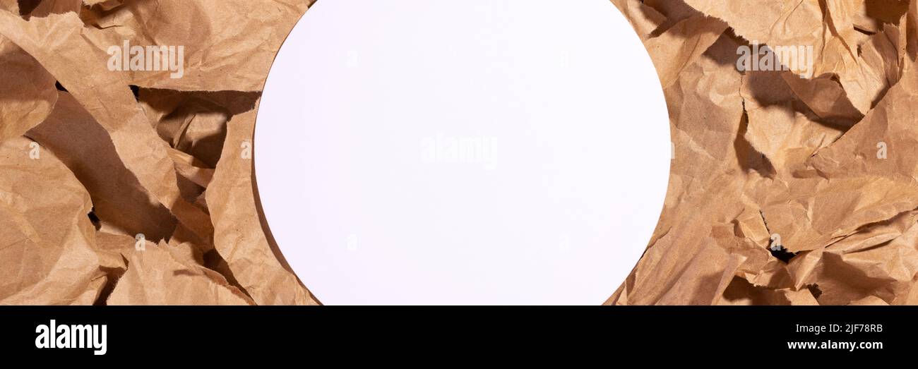 White empty blank circle mockup on multiple pieces of torn brown ...