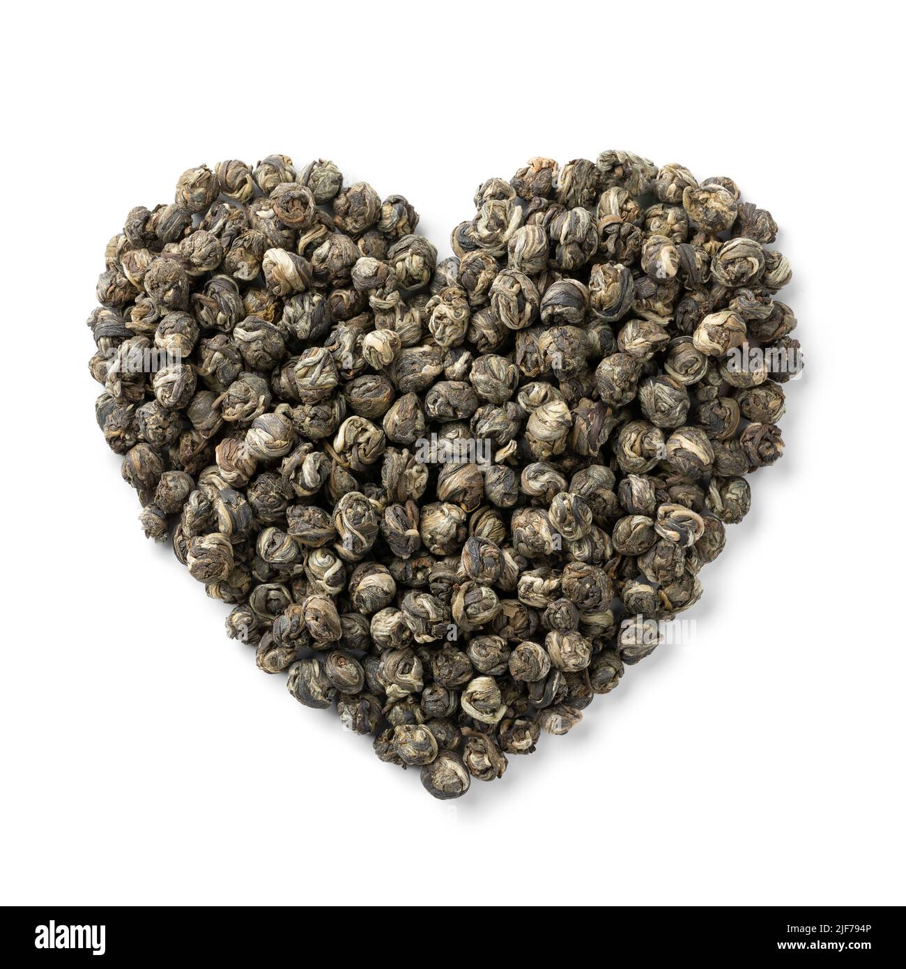 Chinese Jasmine Dragon pearl tea in heart shape close up isolated on ...