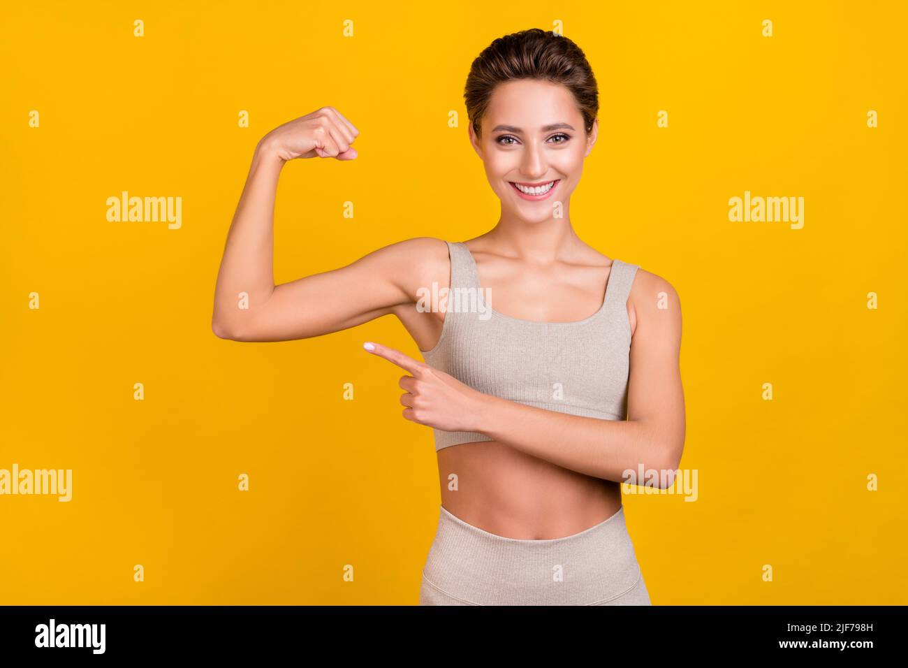 Photo of pretty strong lady direct finger strong biceps muscle wear ...