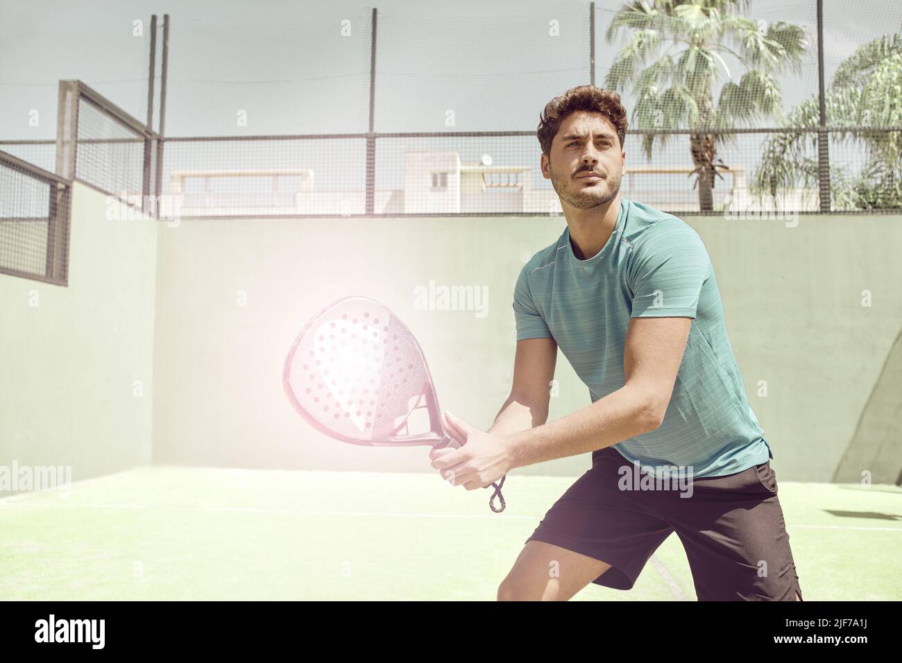 Padel player in position waiting for the ball. Coach and padel player ...