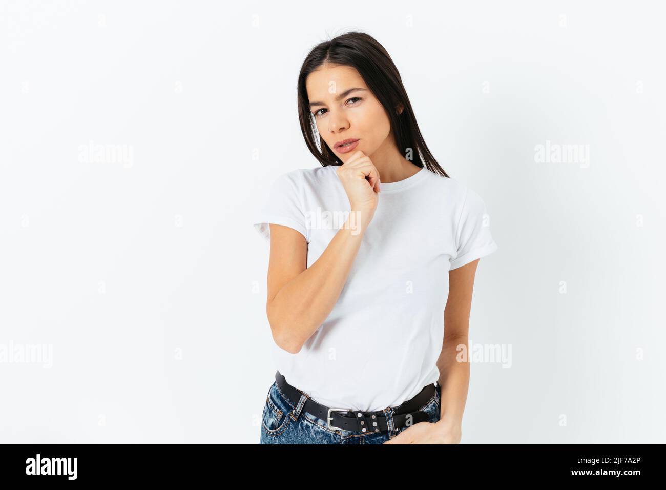 Young woman looking at camera with incredulous expression while ...