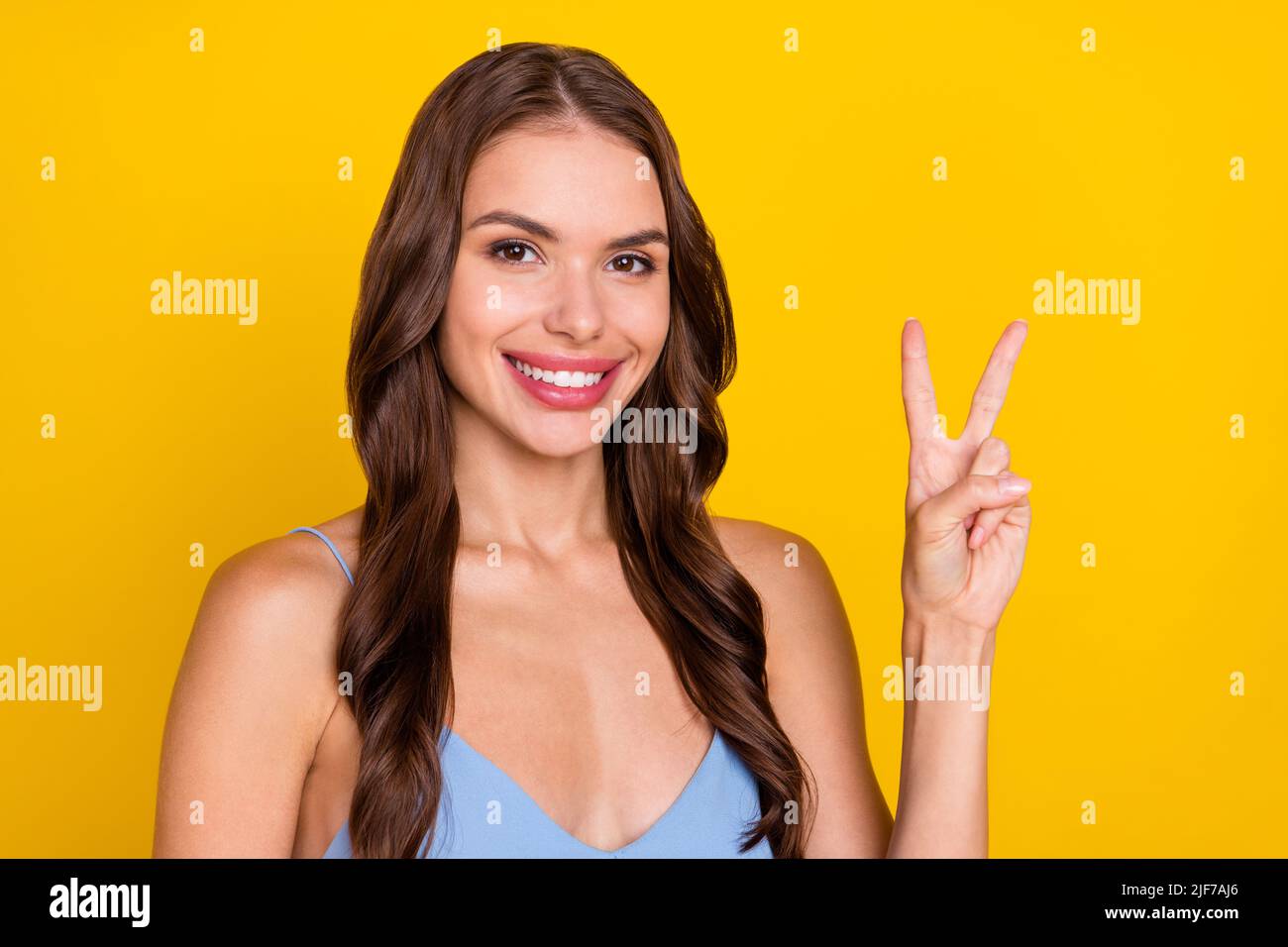 Photo of young cheerful woman happy positive smile show peace cool v ...