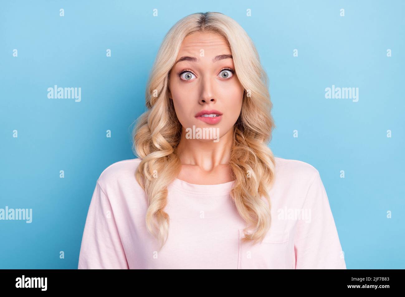 Photo portrait blonde woman curly hair staring amazed biting lips in ...