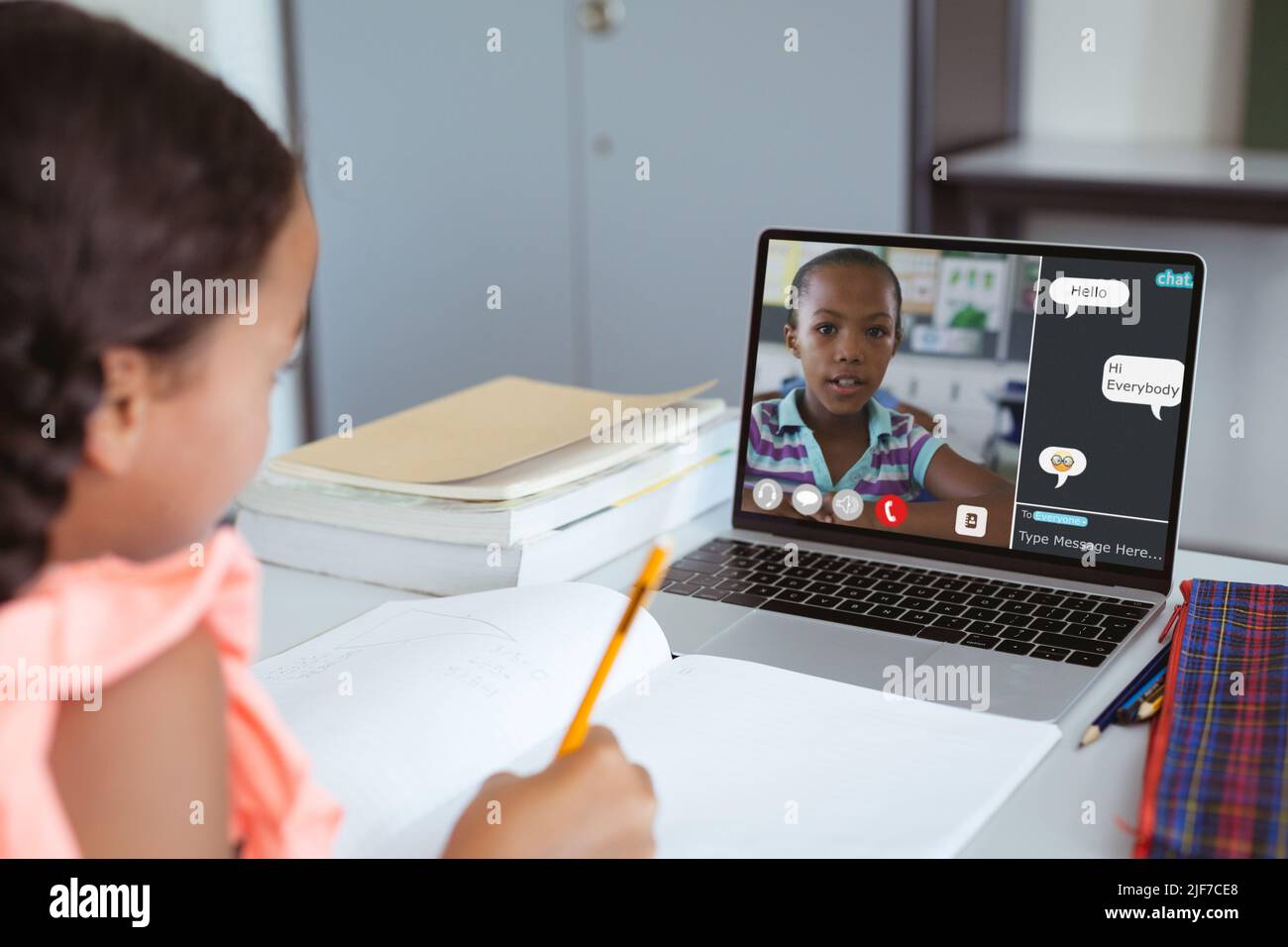 Biracial girl looking at laptop screen with african american student ...
