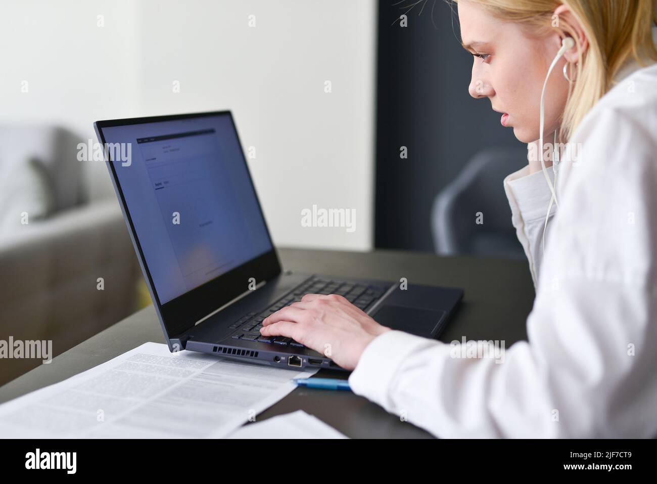 Woman looks intently at her laptop screen Stock Photo - Alamy