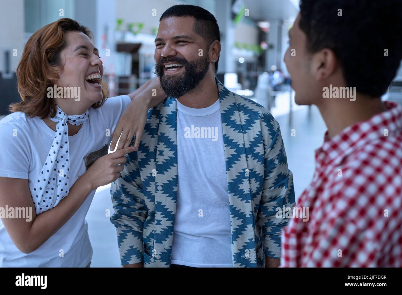 A closeup of a Hispanic group of friends laughing while hanging out ...
