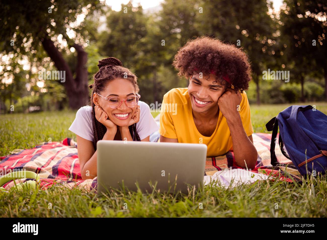 Portrait of handsome beautiful smart clever cheerful couple lying on ...