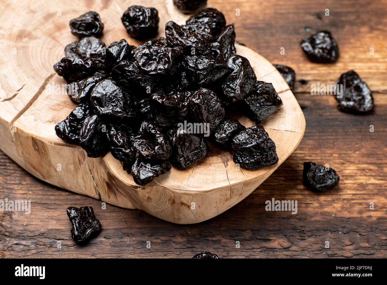 Dried prunes on a wooden background. Dry fruits Stock Photo - Alamy
