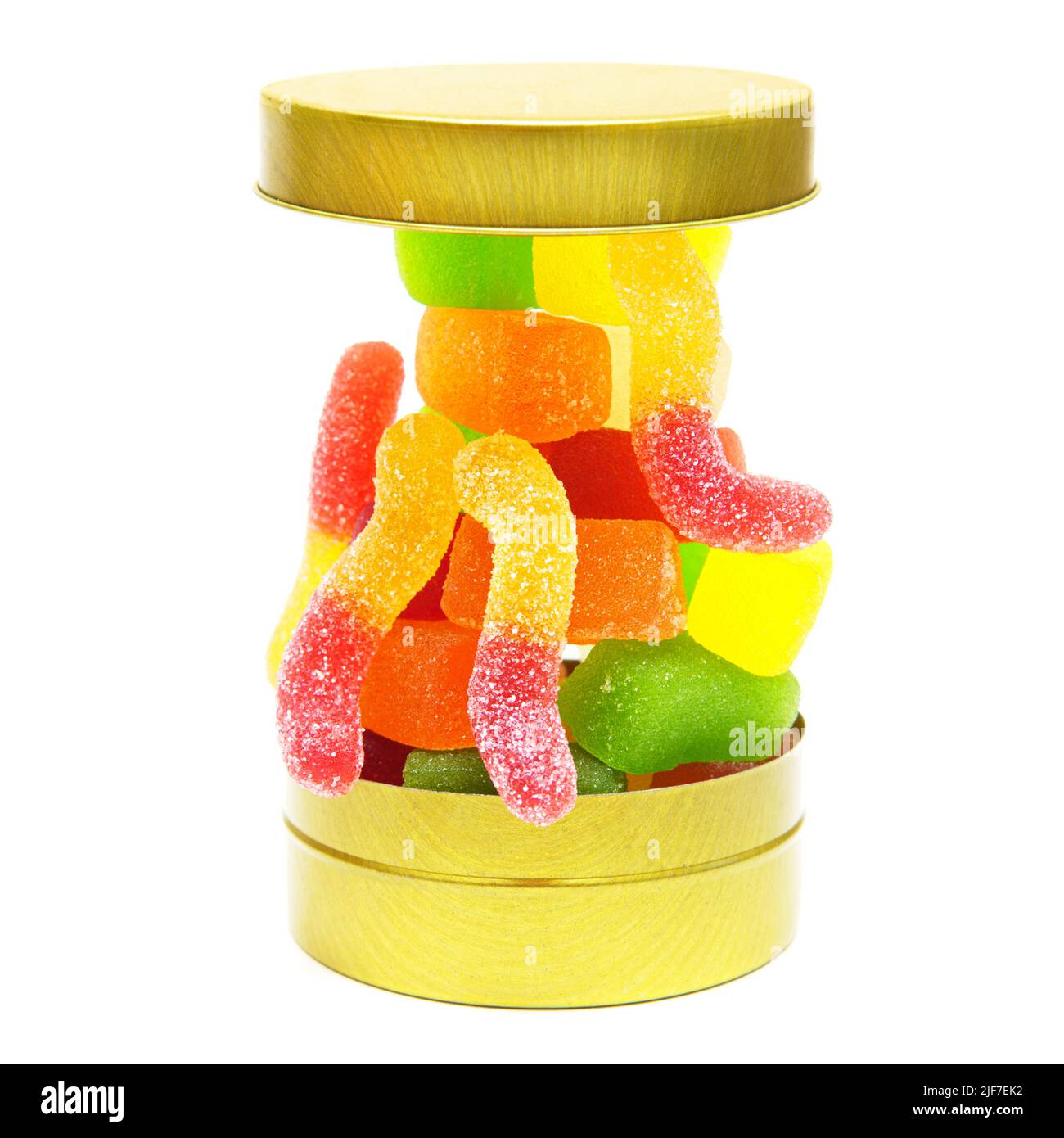 Round tin box full of gummy worms and jelly candies isolated on white ...