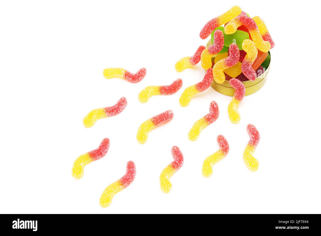 Large pile of gummy worms and jelly candies in a small tin box isolated ...