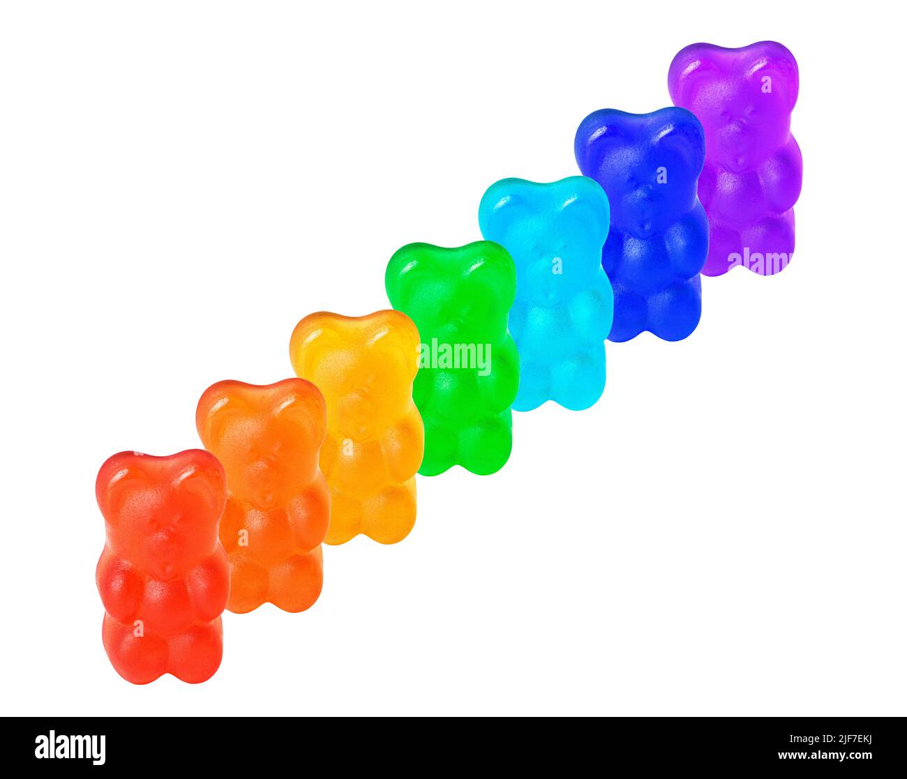 Row of rainbow-colored gummy bears arranged on white background. Jelly ...
