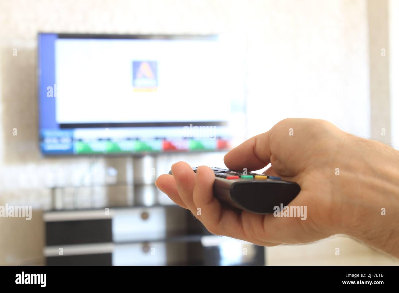 Remote control, a man with a remote control in his hand switches ...