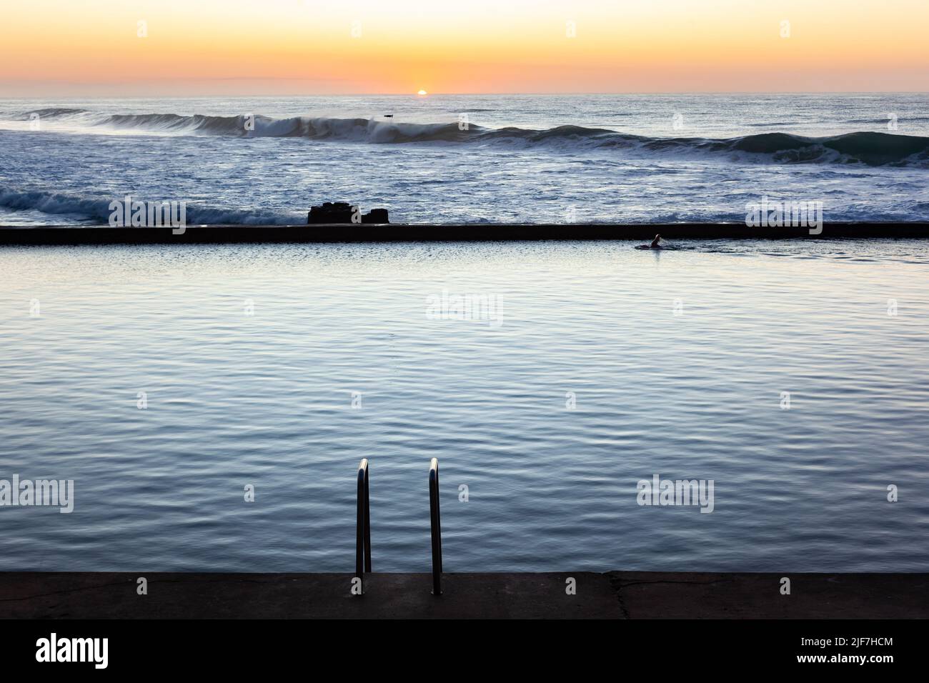 Beach ocean tidal swimming pool early morning color reflections over ...