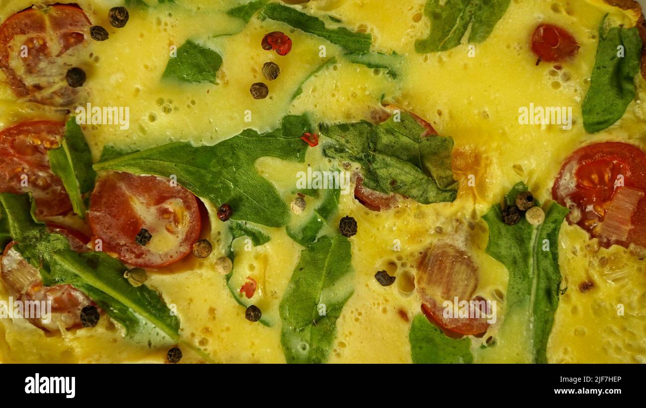 scrambled eggs fried eggs omelet with tomatoes and garlic in a rustic ...