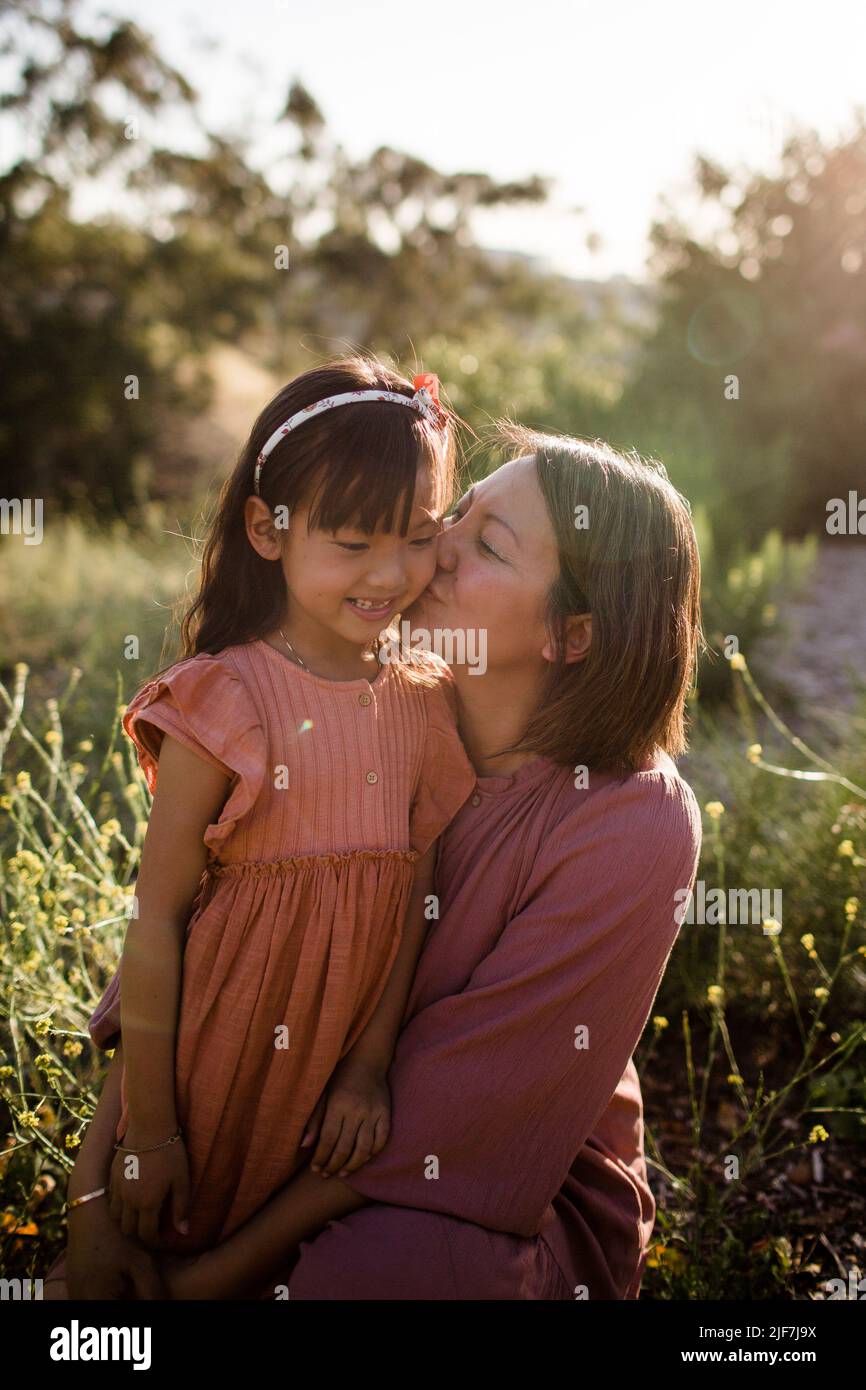 Asian daughter hugging kissing mother hi-res stock photography and images - Alamy