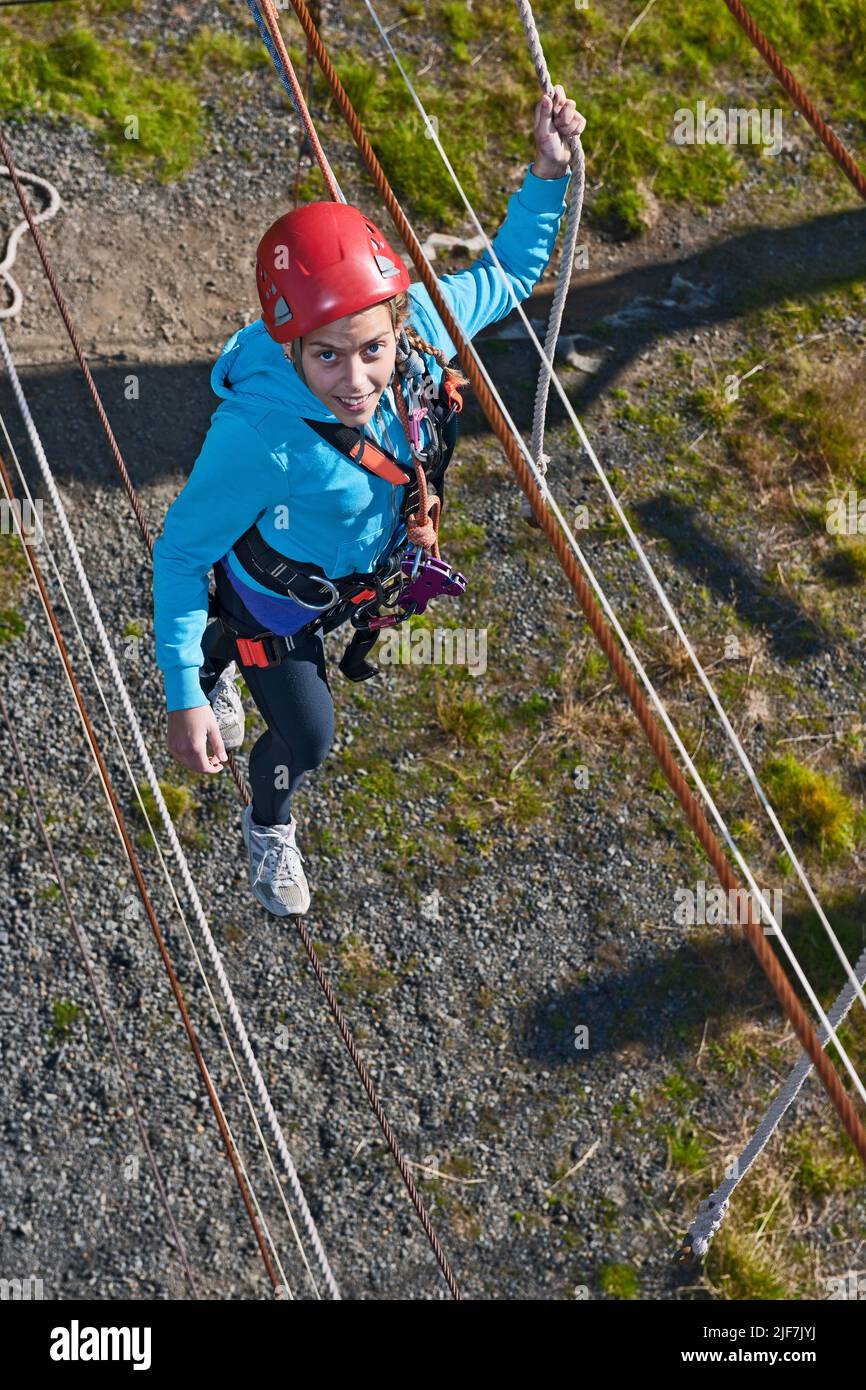 teenage girl balance on rope at high rope playground in Iceland Stock ...