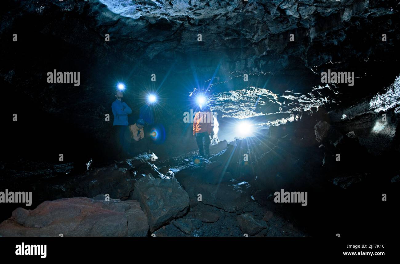 group of scientists exploring the Leidarendi lava cave in Iceland Stock ...