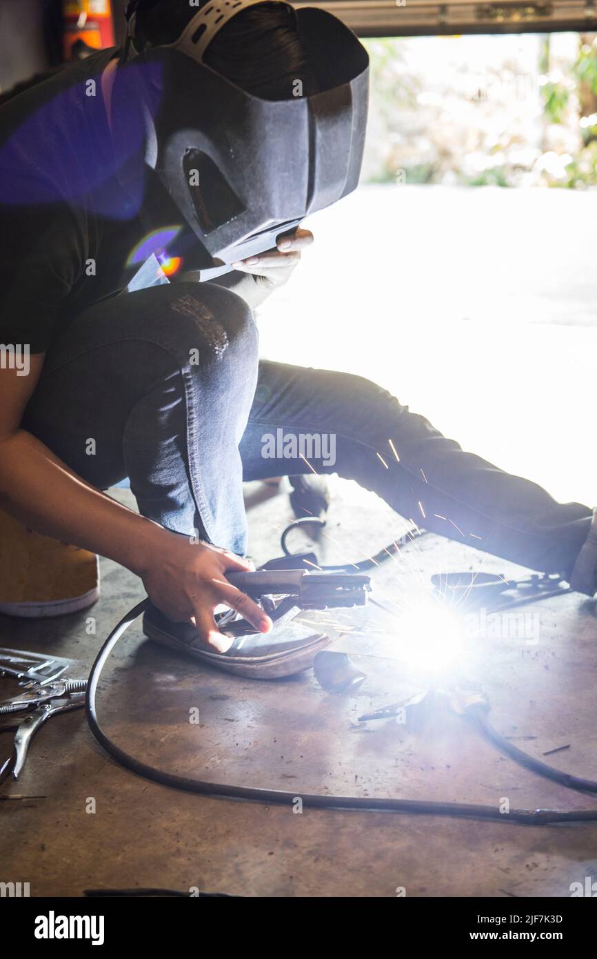 mechanic welding at custom bike shop in Bangkok Stock Photo - Alamy