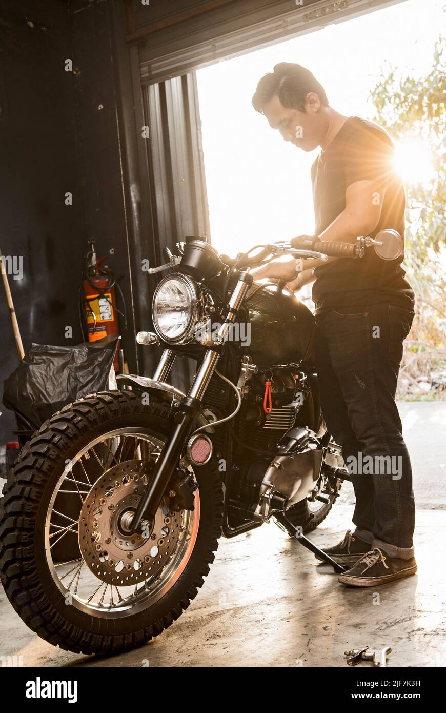 mechanic working on motorcycle at custom bike shop in Bangkok Stock ...