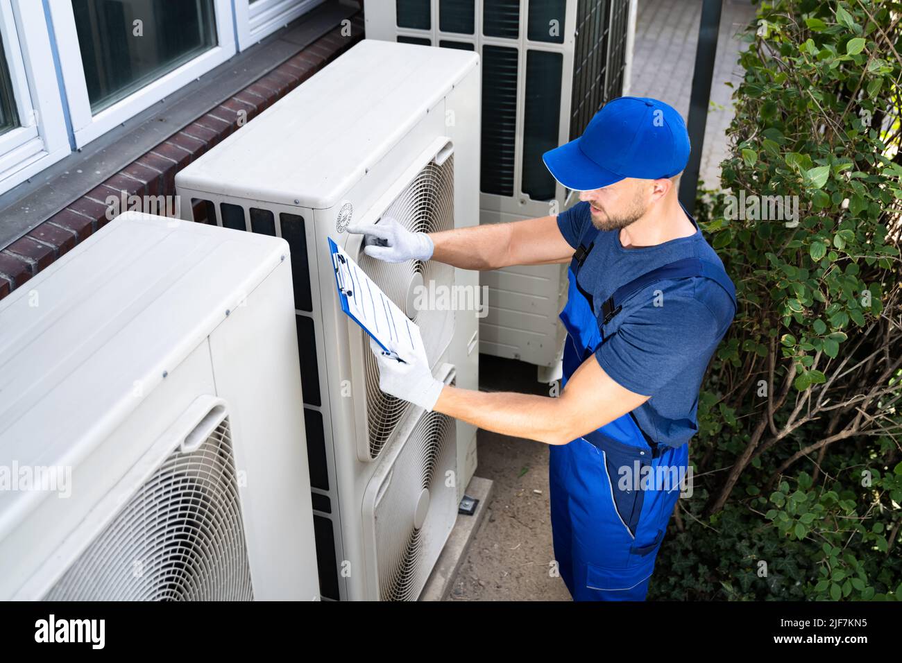 Two Electricians Men Wearing Safety Jackets Checking Air Conditioning ...