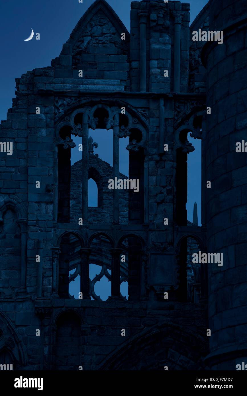 Evening sky and quarter moon behind ancient European stone architecture ...