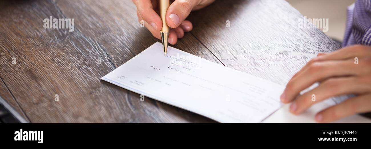 Signing a cheque hi-res stock photography and images - Alamy