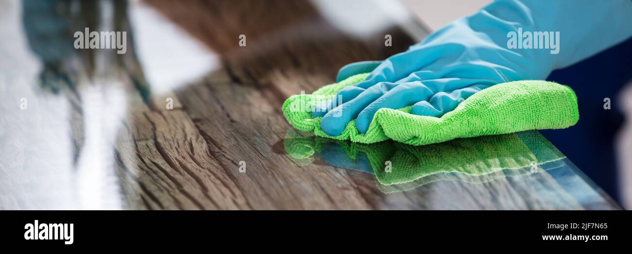 Close-up Of A Janitor's Hand Wearing Gloves Cleaning Desk With Green ...