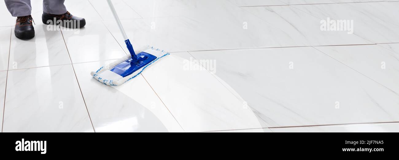 Worker Mopping Floor With Mop In Kitchen Stock Photo - Alamy