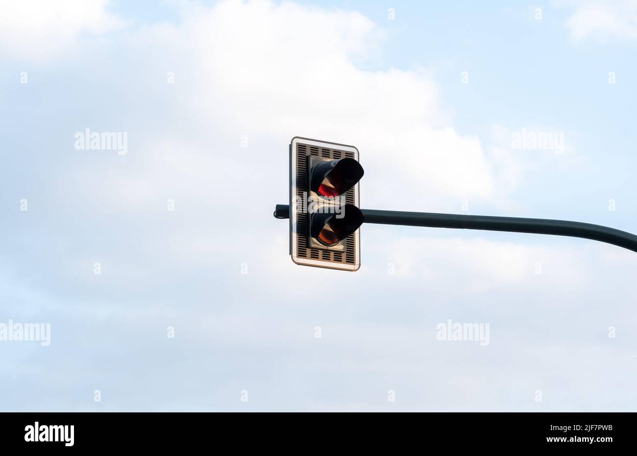 Single set of double traffic lights, object isolated on light blue sky ...