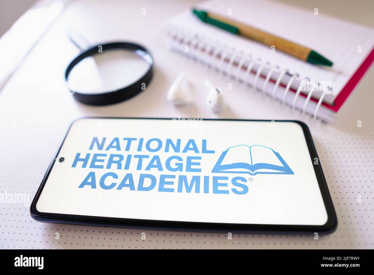 In this photo illustration the National Heritage Academies logo seen displayed on a smartphone ...