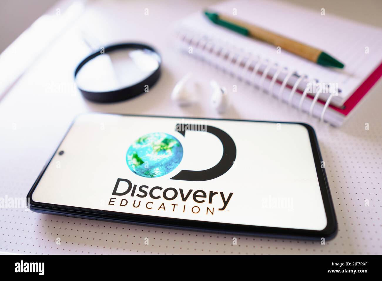 In this photo illustration the Discovery Education logo seen displayed on a smartphone next to a ...