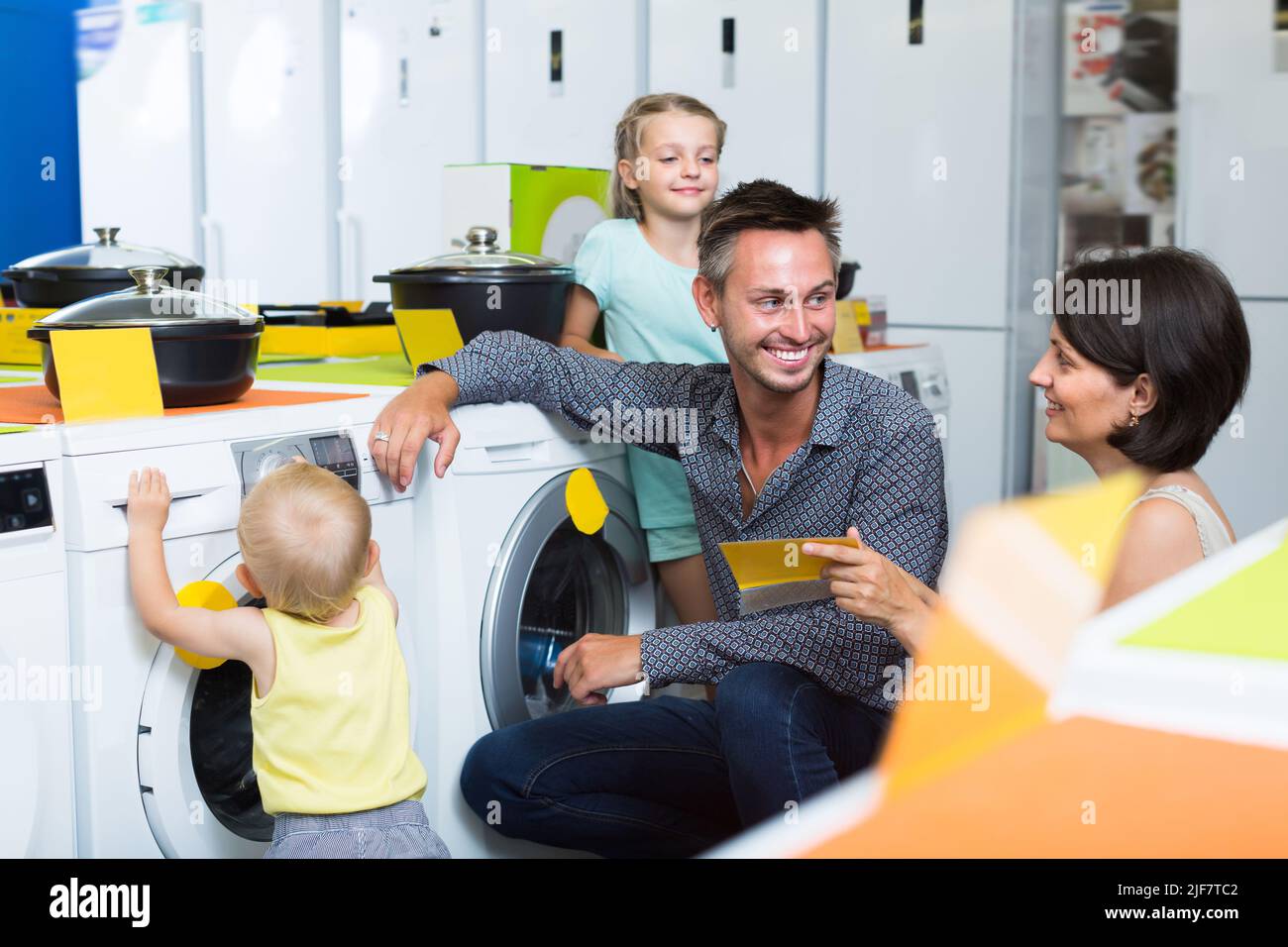 Family choosing washing machine Stock Photo - Alamy