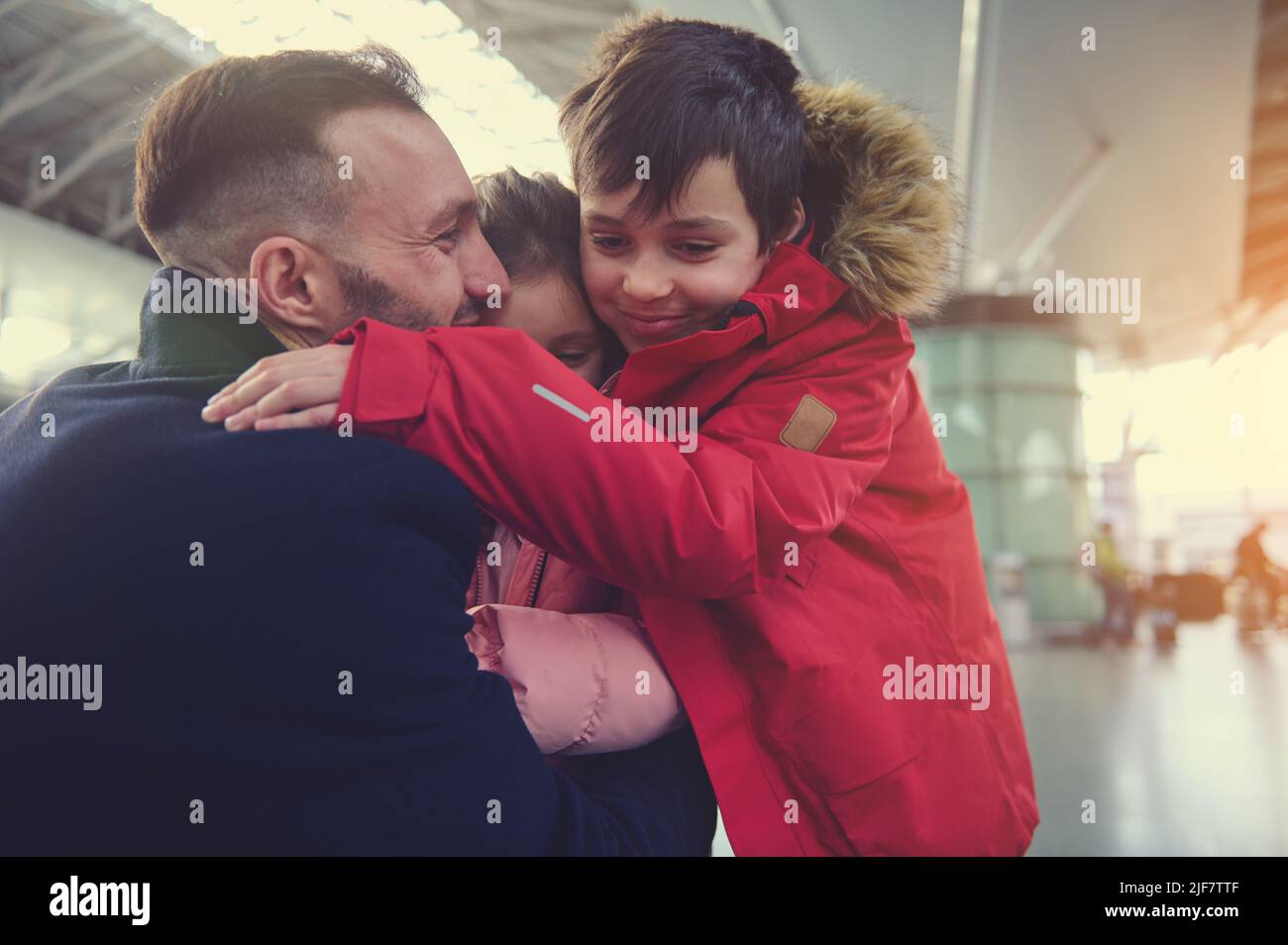 Emotional portrait of a happy young Caucasian man - father hugging his ...