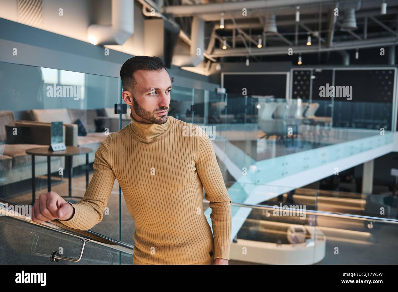 Handsome confident young Caucasian man in casual attire, confidently ...